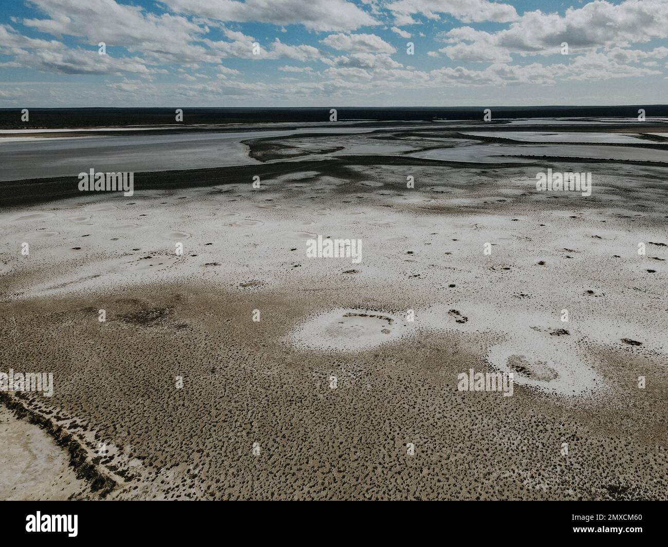 An aerial video of a dry empty field on a sunny day with unique ...