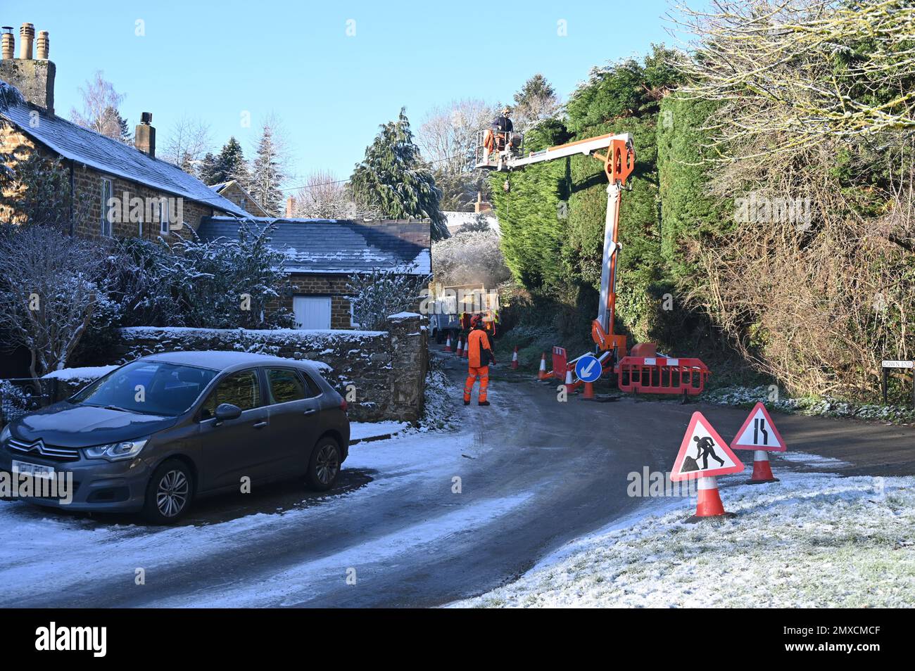 Tree pruning using a cherrypicker after a brief snowfall in the north ...