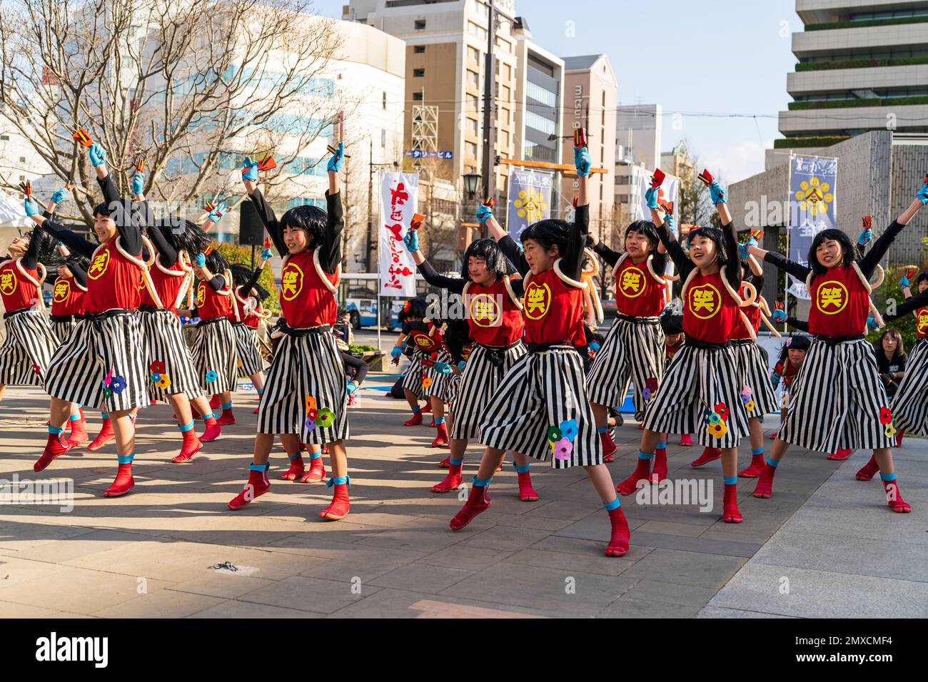 Japanese team of female child Yosakoi dancers dancing and holding ...