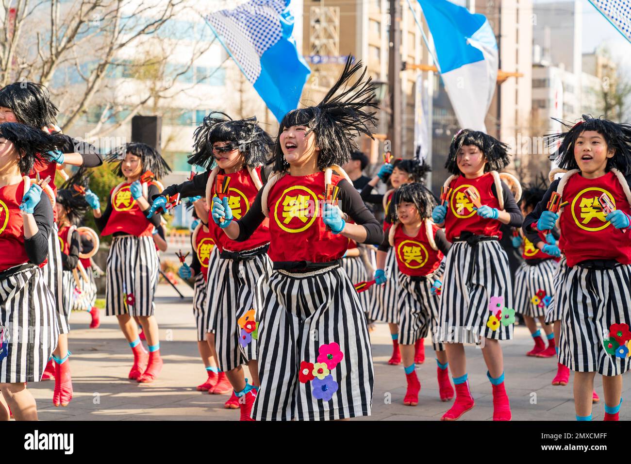 Japanese team of female child Yosakoi dancers dancing and holding ...