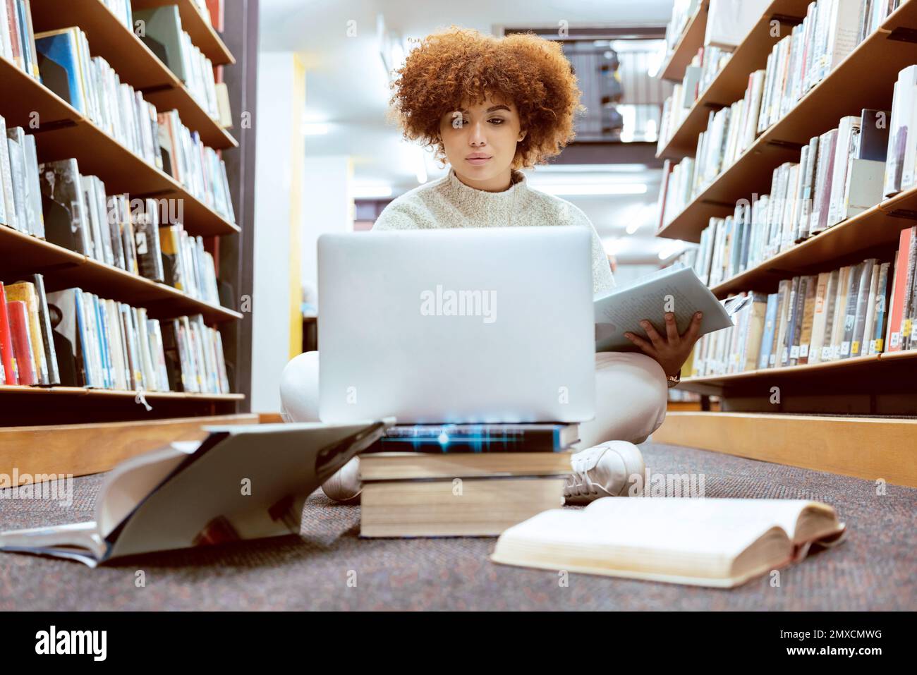 College library learning, laptop and black woman student working on the ...
