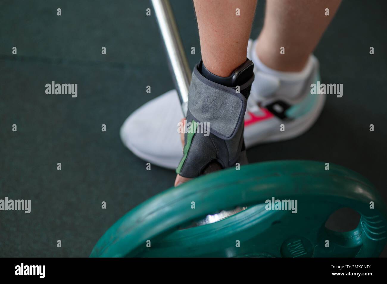 Man with a sports figure doing exercise on simulator in the gym. High ...