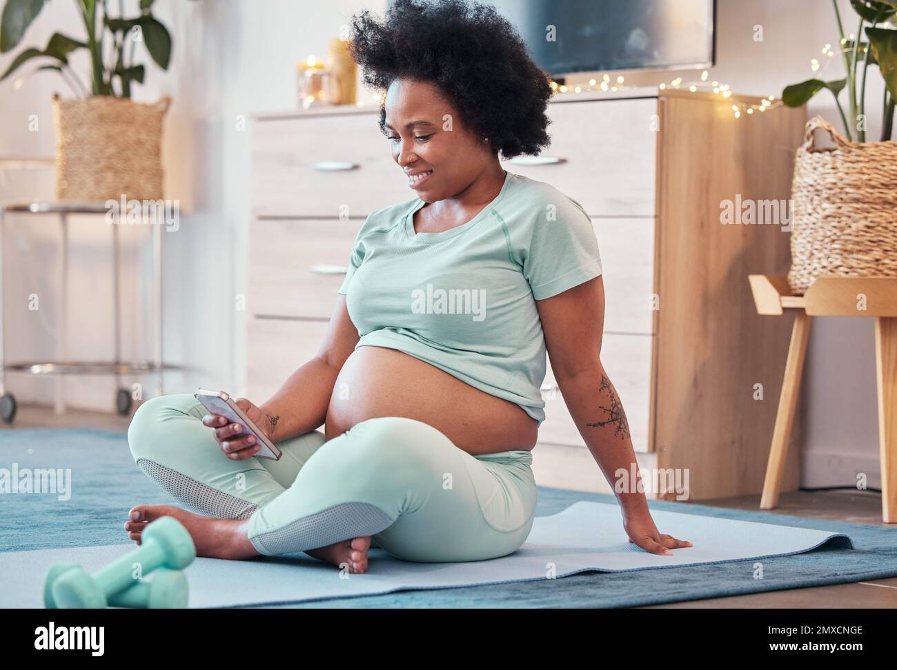 Yoga, pregnant and black woman with phone in home for social media and ...