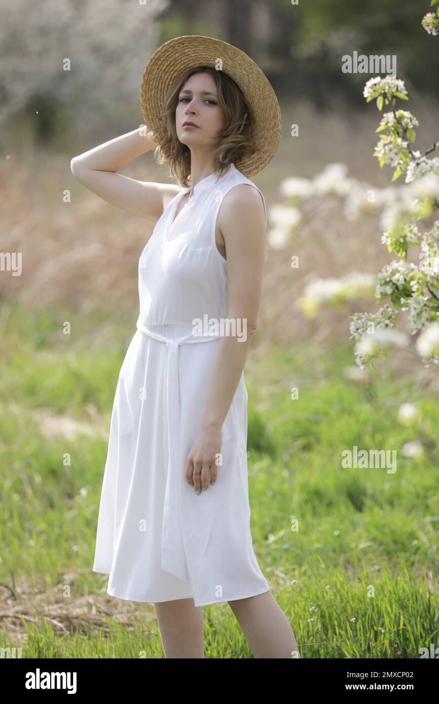 Spring fashion campaign. Outdoor portrait of female model in white ...