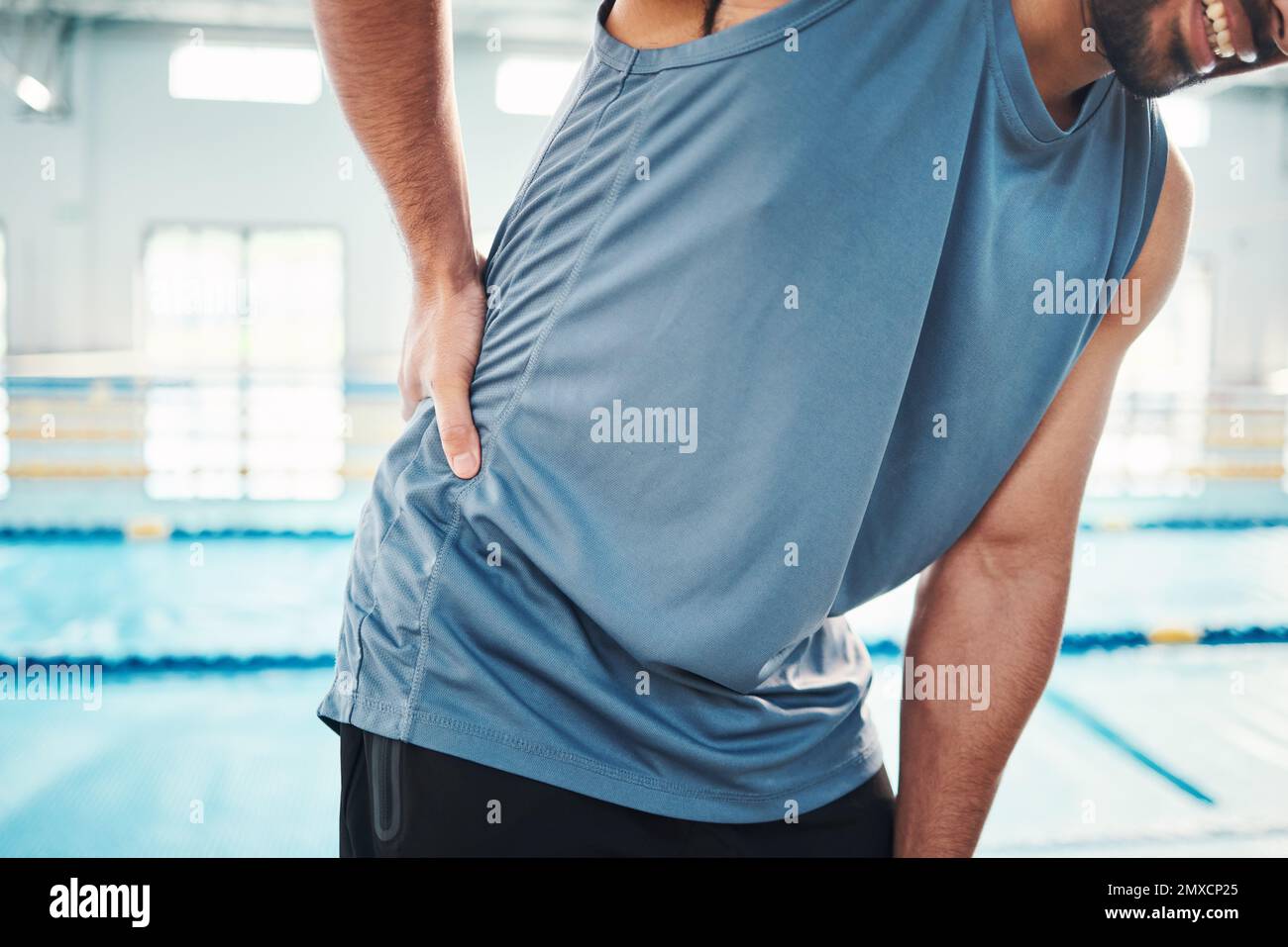Sports, back pain and man by swimming pool with muscle ache, injury and ...