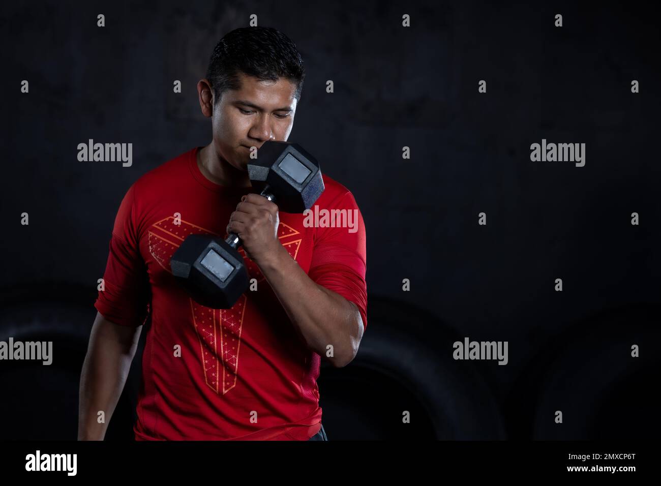 a young mexican latino man doing crossfit training and weightlifting ...