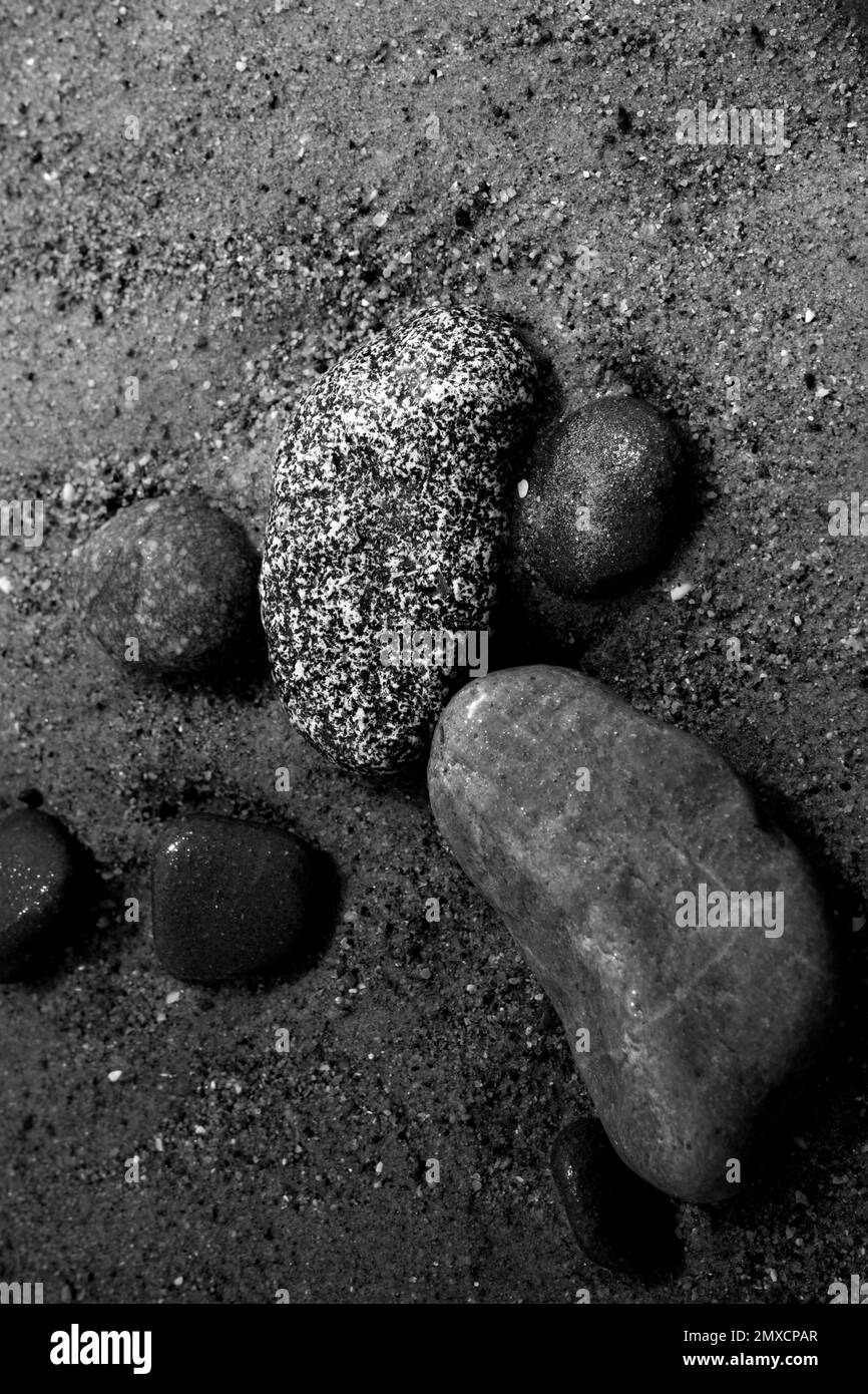 A grayscale of stones on a sandy beach Stock Photo - Alamy