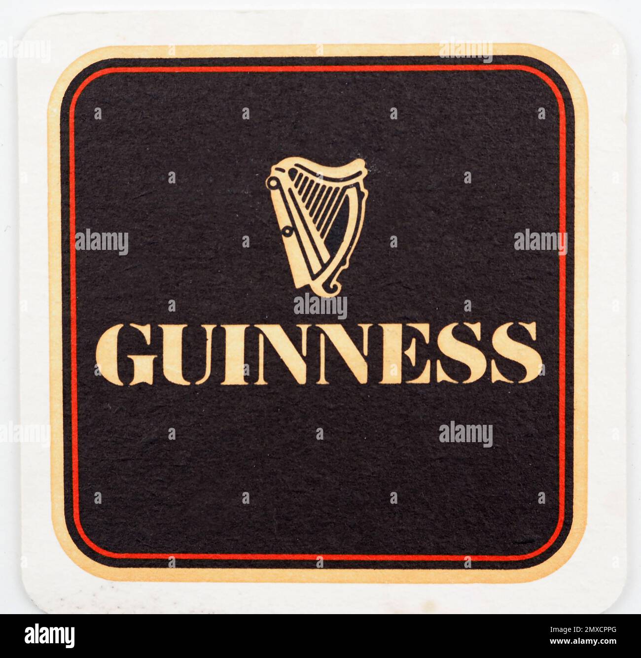 Vintage cardboard beer coaster with logo Guinnes. Guinness is a beer ...