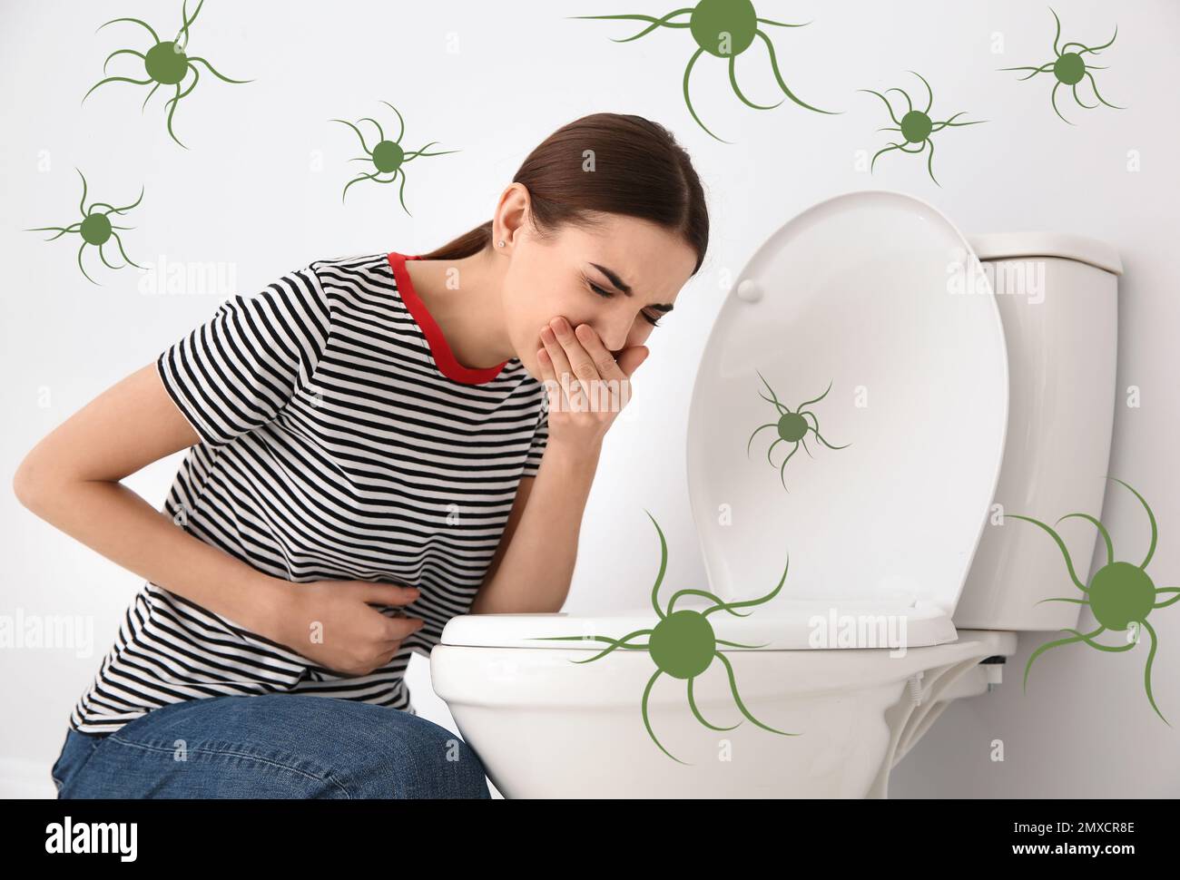 Young woman suffering from nausea at toilet bowl and bacteria ...