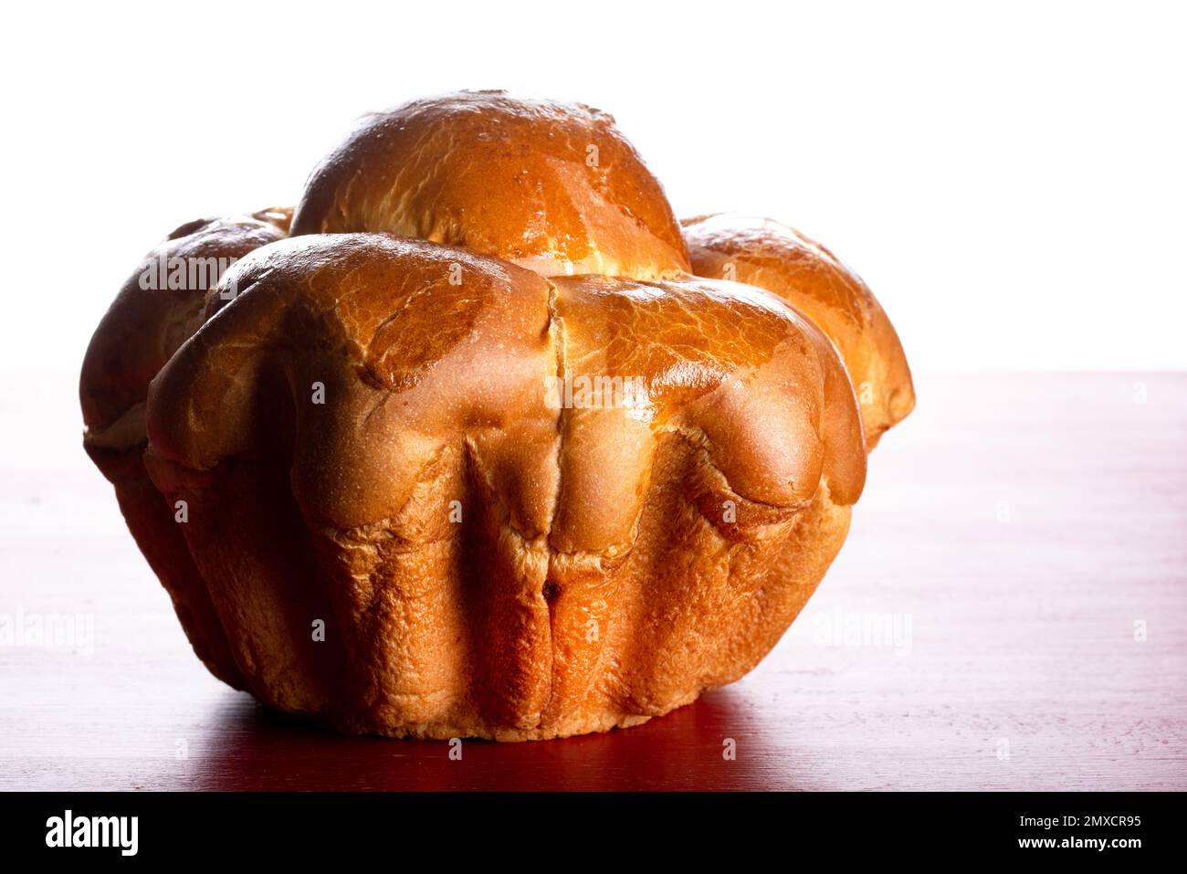 Close up shot of a traditional french brioche on a red surface Stock ...