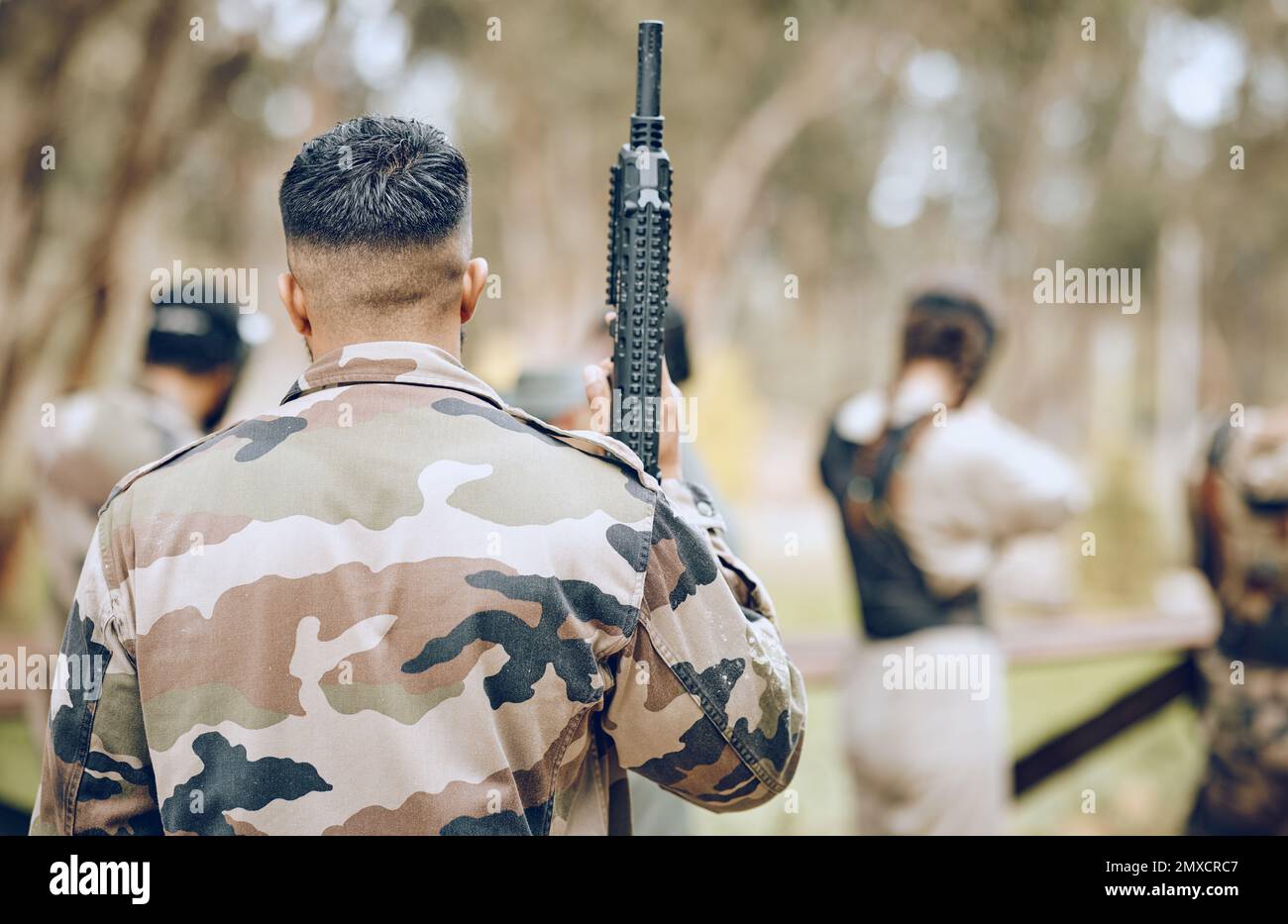 Paintball, soldier or man with a gun in a shooting game playing on a ...