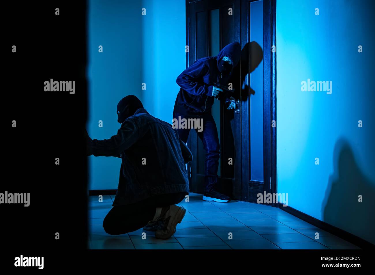 Dangerous criminals with gun and crow bar intruding into apartment ...