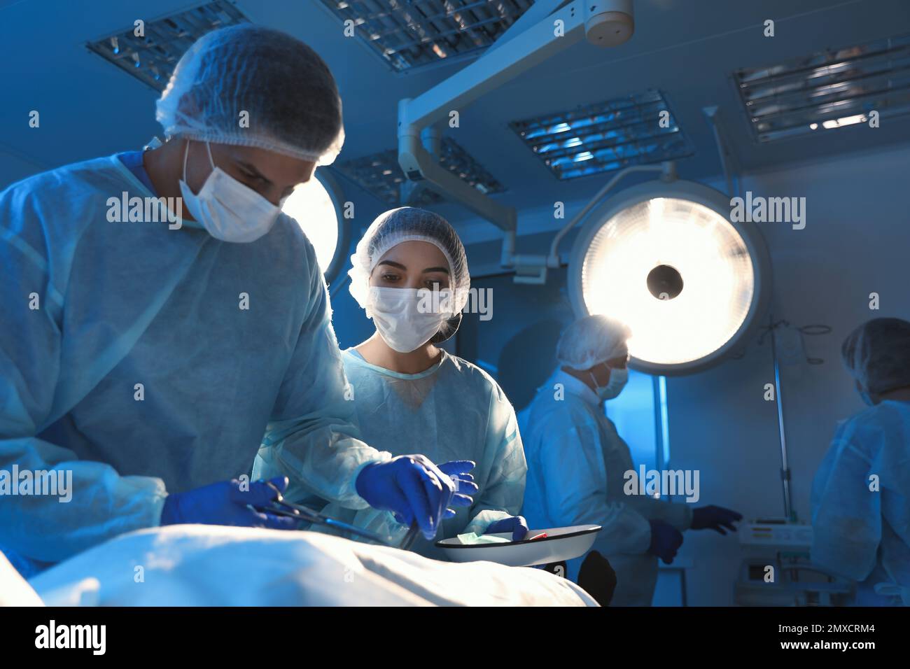 Team of professional doctors performing operation in surgery room Stock ...
