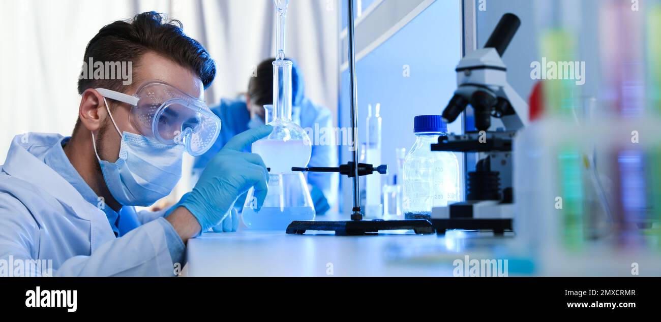 Young scientist doing research and analysis in chemical laboratory ...