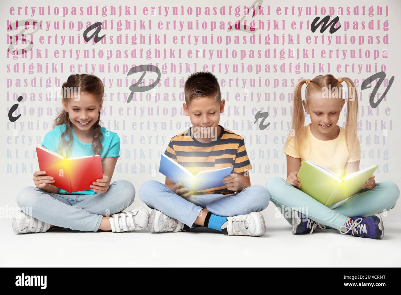 Little children reading books on grey background Stock Photo - Alamy