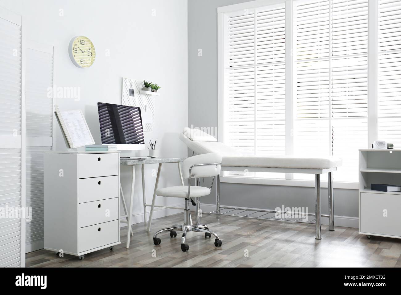 Modern medical office interior with computer and examination table ...