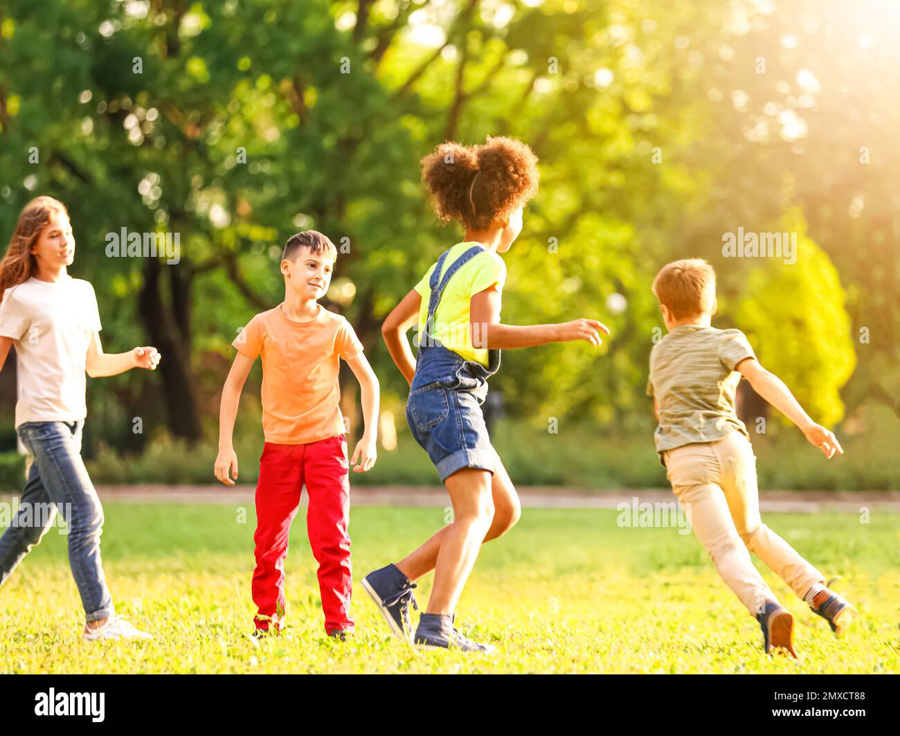 School holidays. Group of happy children playing outdoors Stock Photo ...