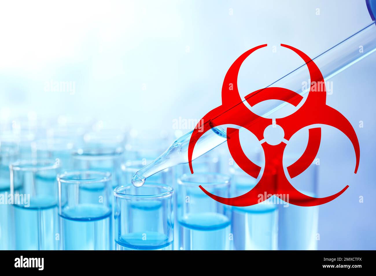 Poison sign and dropping sample into test tube with light blue liquid ...
