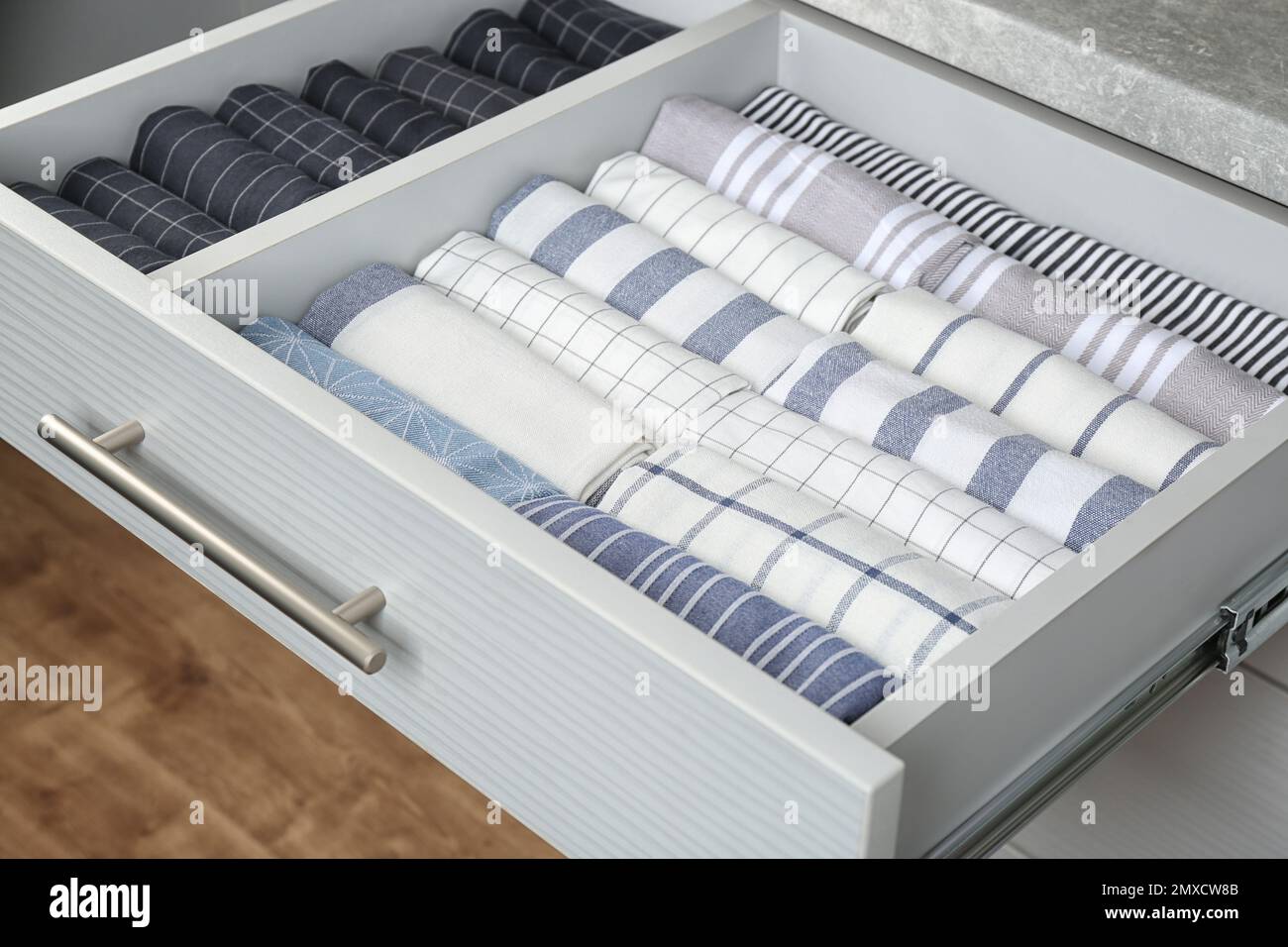 Open drawer with folded towels. Order in kitchen Stock Photo - Alamy