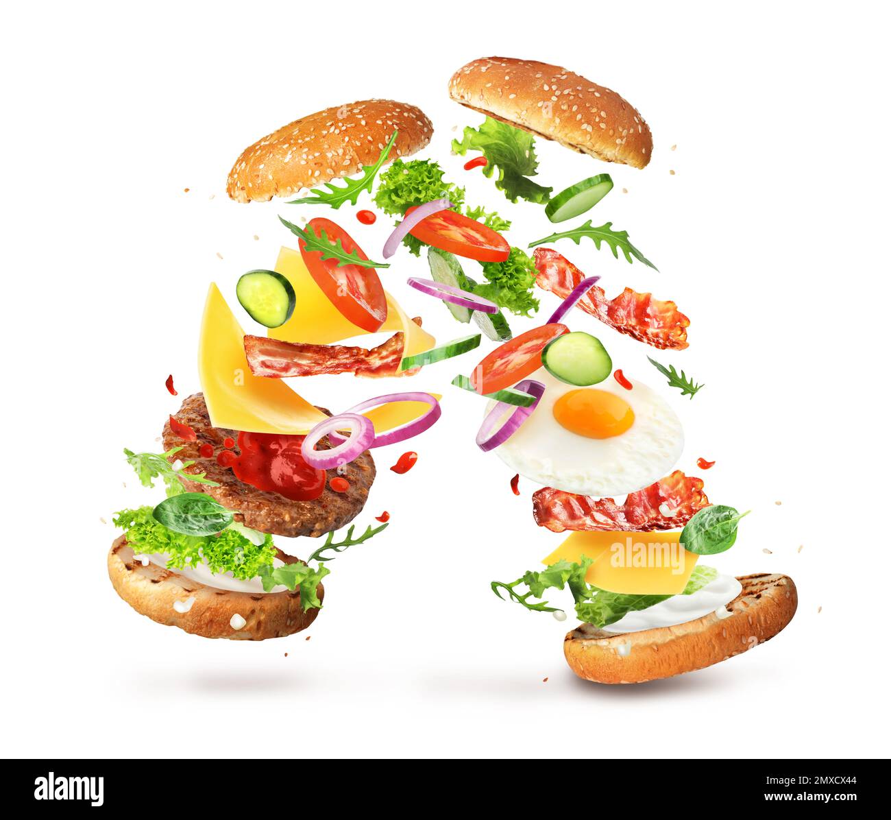 Delicious burgers with different flying ingredients on white background ...