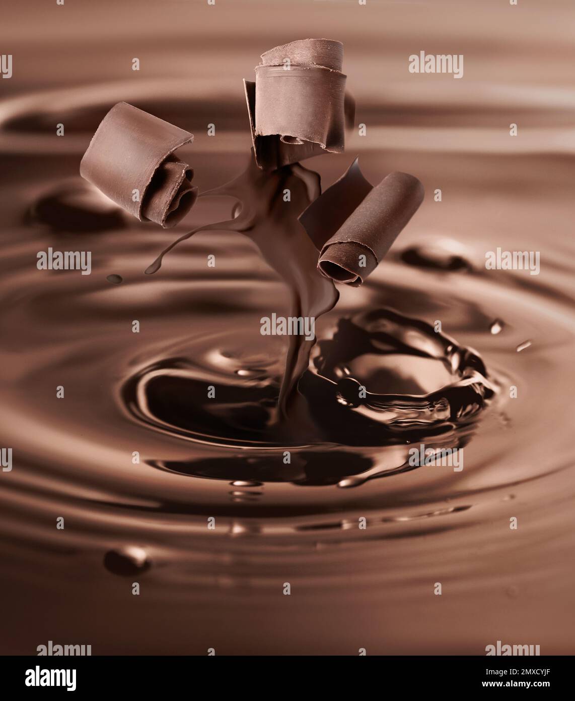 Yummy melted chocolate splashing with falling curls Stock Photo - Alamy