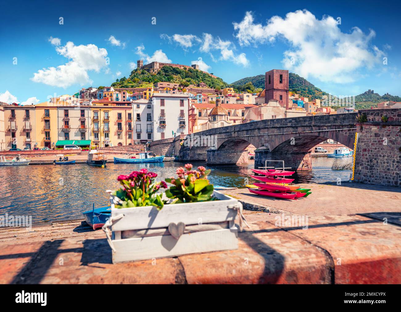 Colorful summer cityscape of Bosa town with Ponte Vecchio bridge across ...