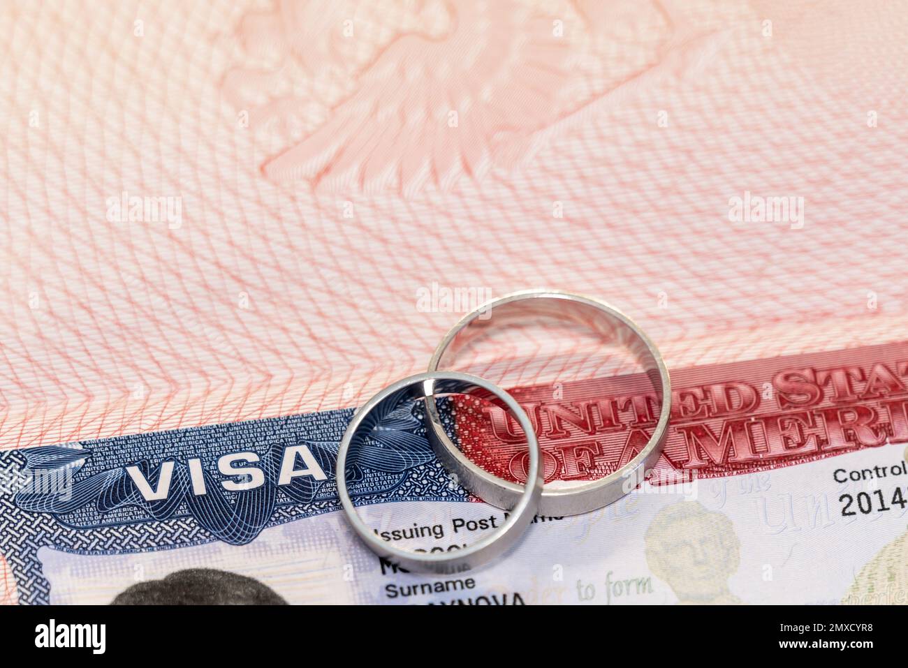 Closeup of wedding rings on usa visa as concept of marriage of ...