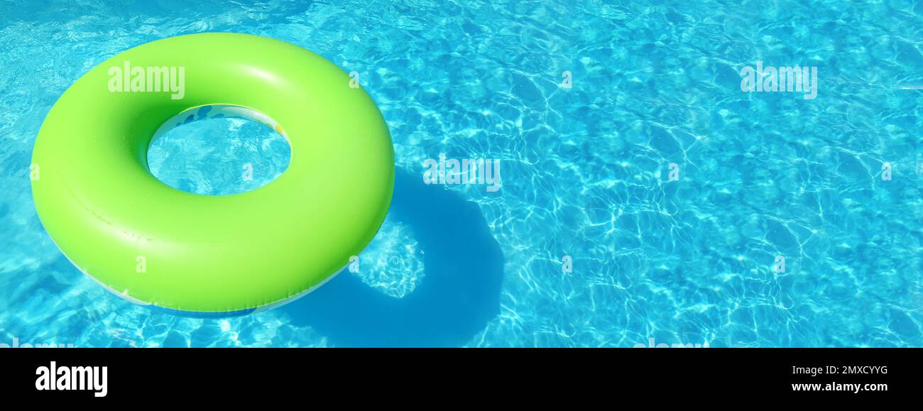 Bright inflatable ring floating in swimming pool on sunny day, space ...