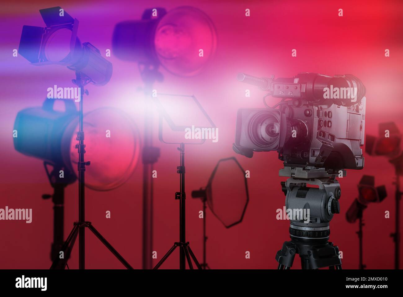 Modern professional video camera and lighting equipment in studio Stock ...