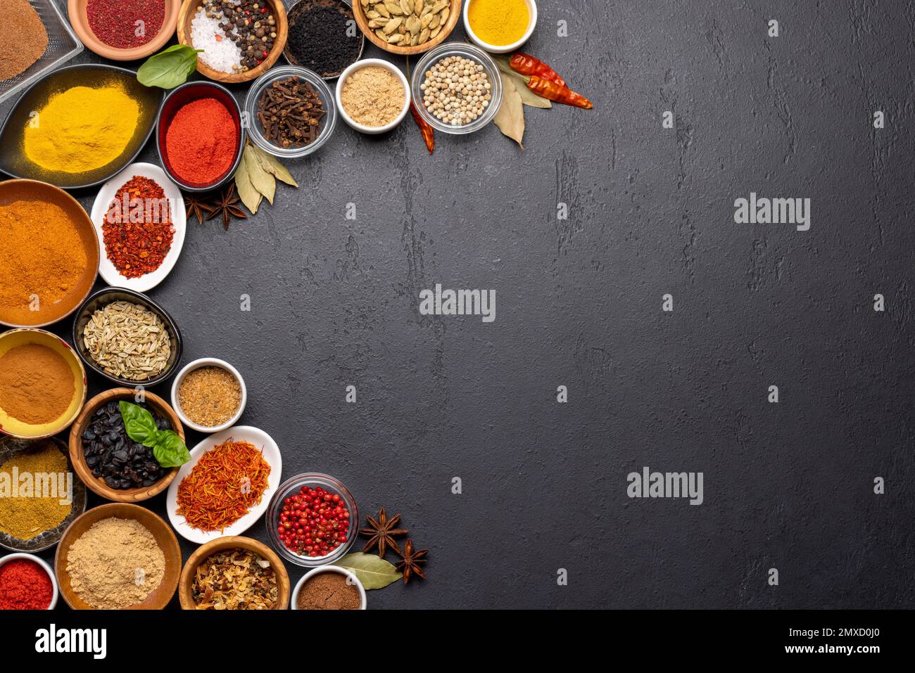 Various spices in bowls on stone table. With copy space for your menu ...
