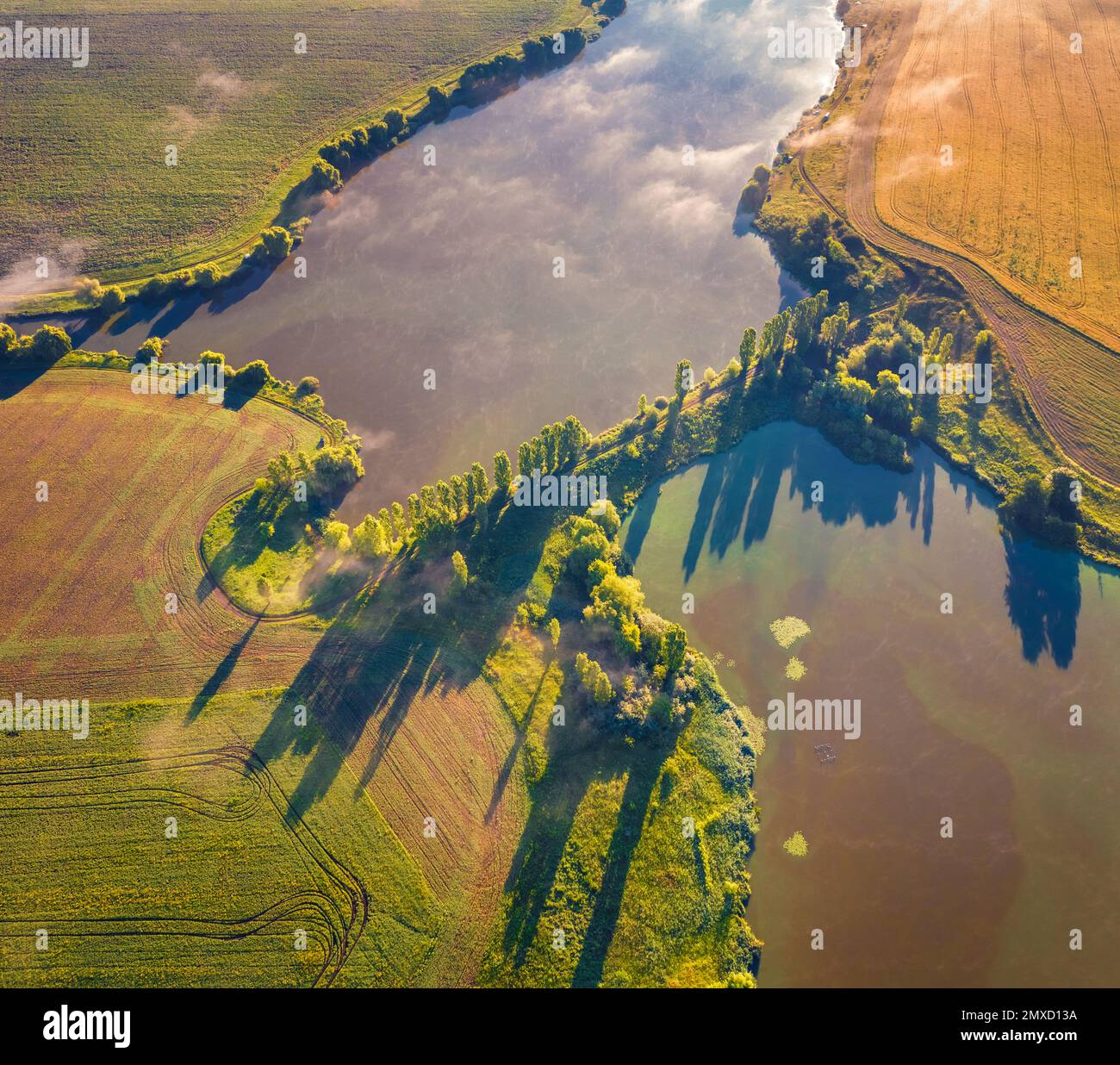Straight down view from flying drone of dam on the lake. Misty morning ...