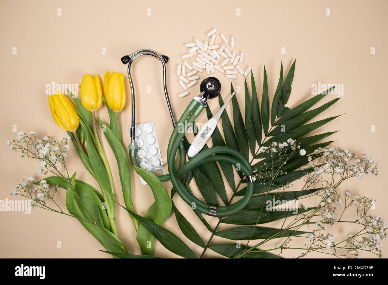 Bouquet of flowers and stethoscope on a beige background, happy doctors ...