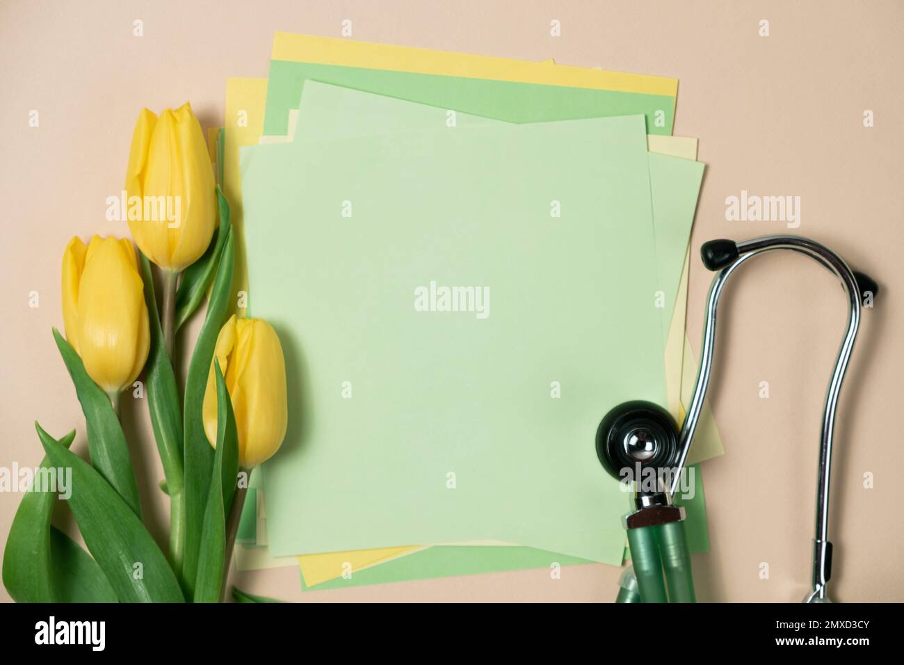 Spring and medicine - yellow tulips and stethoscope with space for text ...