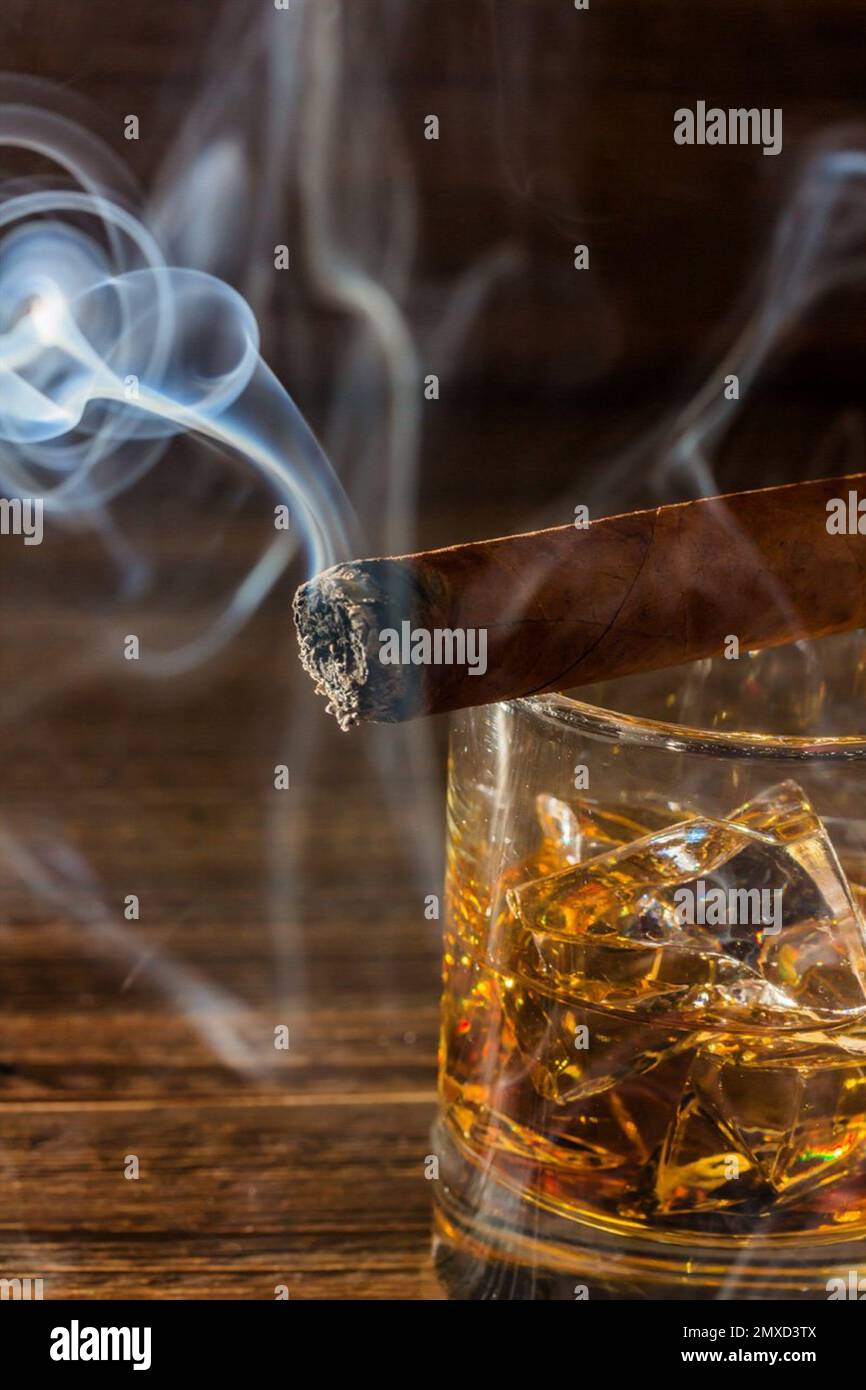 Cigar and whisky, symbol of addiction and pleasure Stock Photo - Alamy