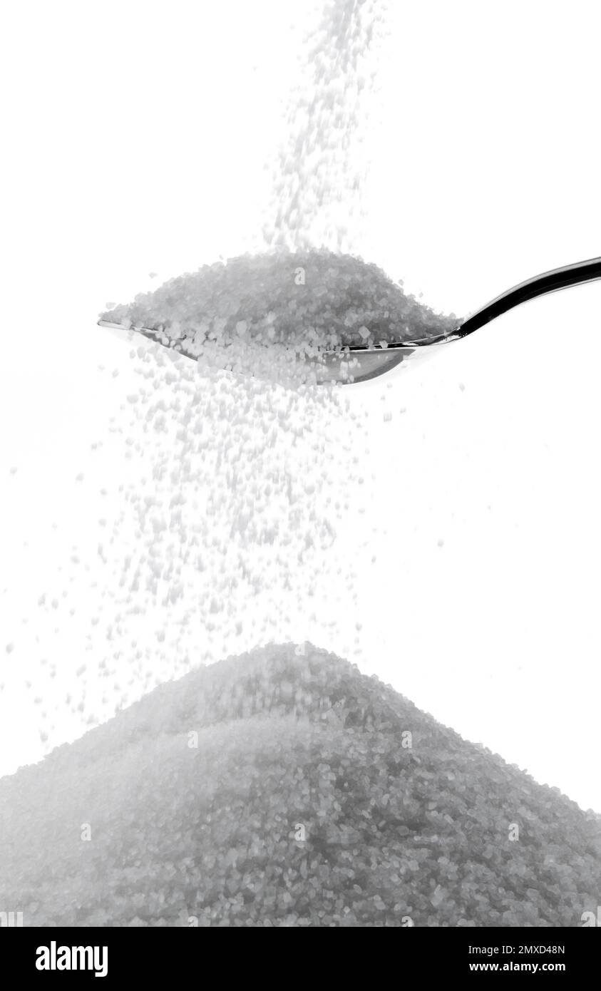 white sugar falling from a teaspoon onto a heap of sugar Stock Photo - Alamy