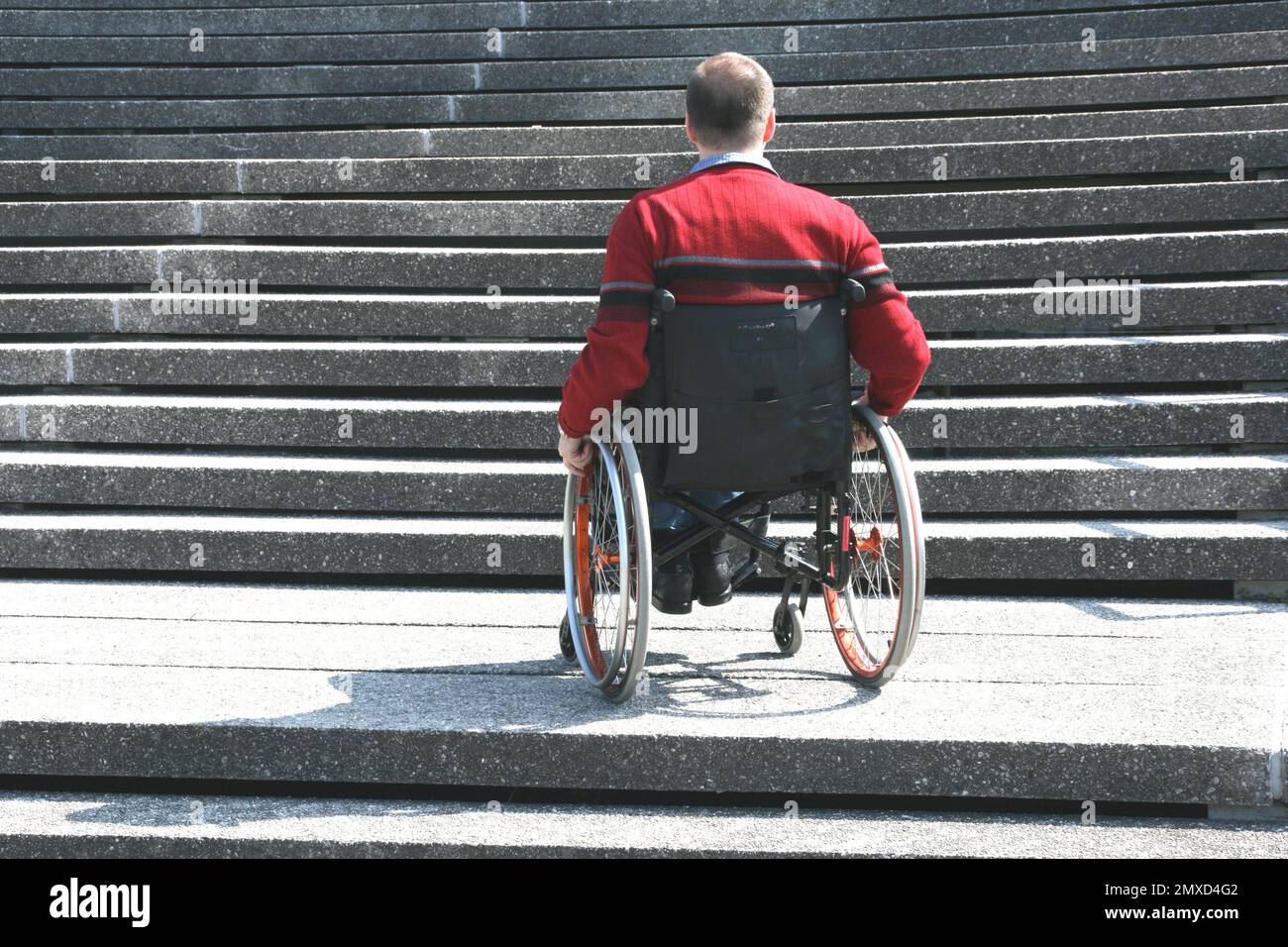 wheelchair user standing in front of a non-barrier-free outside ...