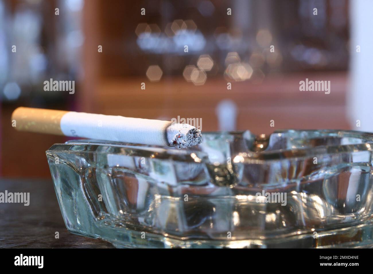 smouldering cigarette in an ashtray Stock Photo - Alamy