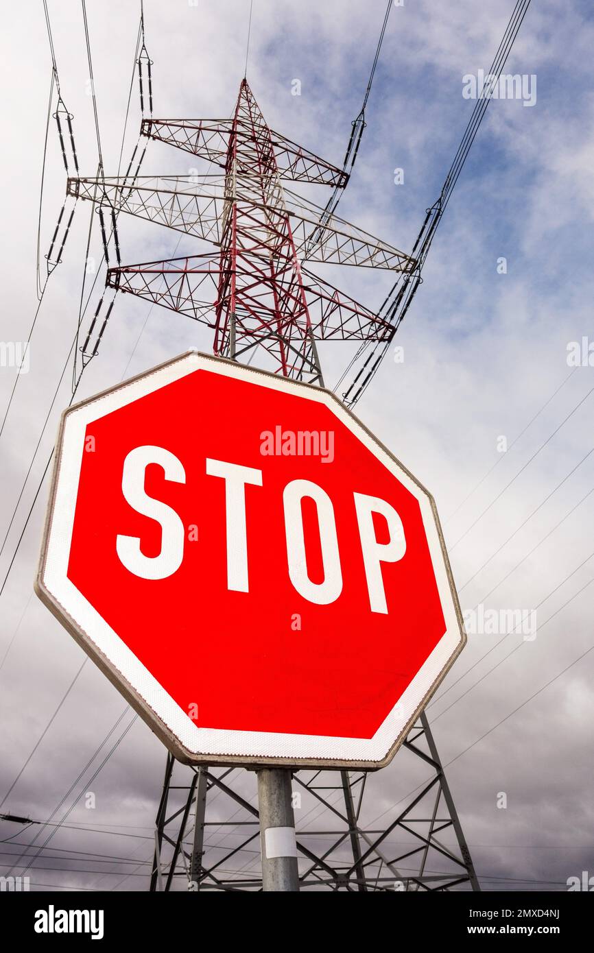 high-voltage transmission pole with power lines, 'stop sign' warns in ...