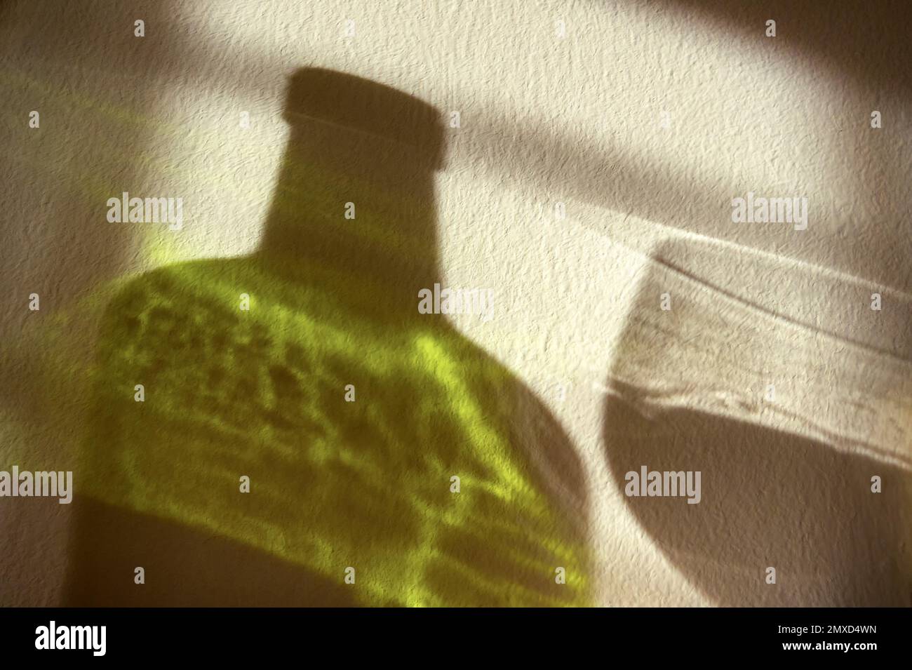 shadows cast by red wine bottle and glass Stock Photo - Alamy