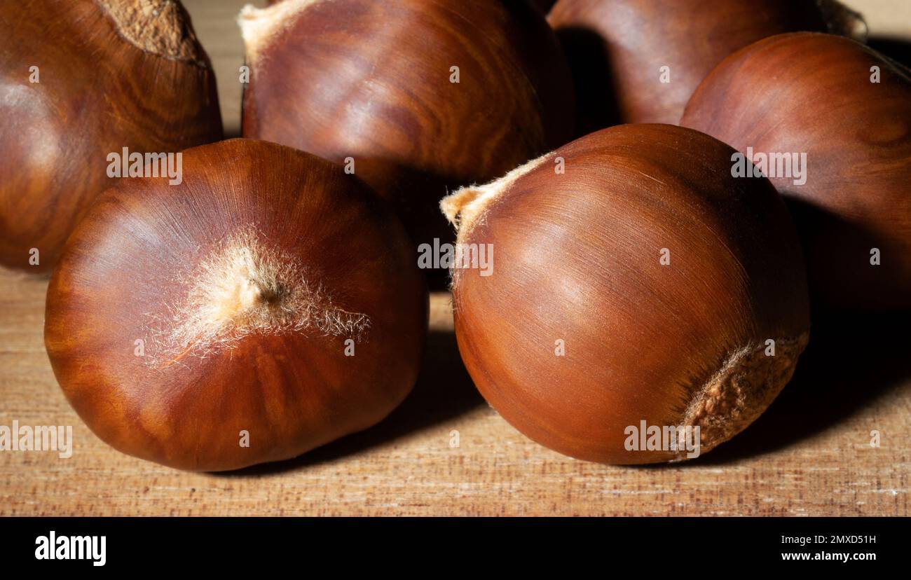 Christmas chestnuts ready to roast resting on a wood table Stock Photo ...