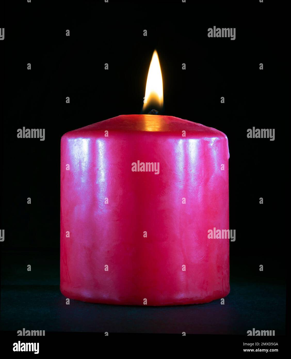 Red Candle burning with a dark background behind Stock Photo - Alamy