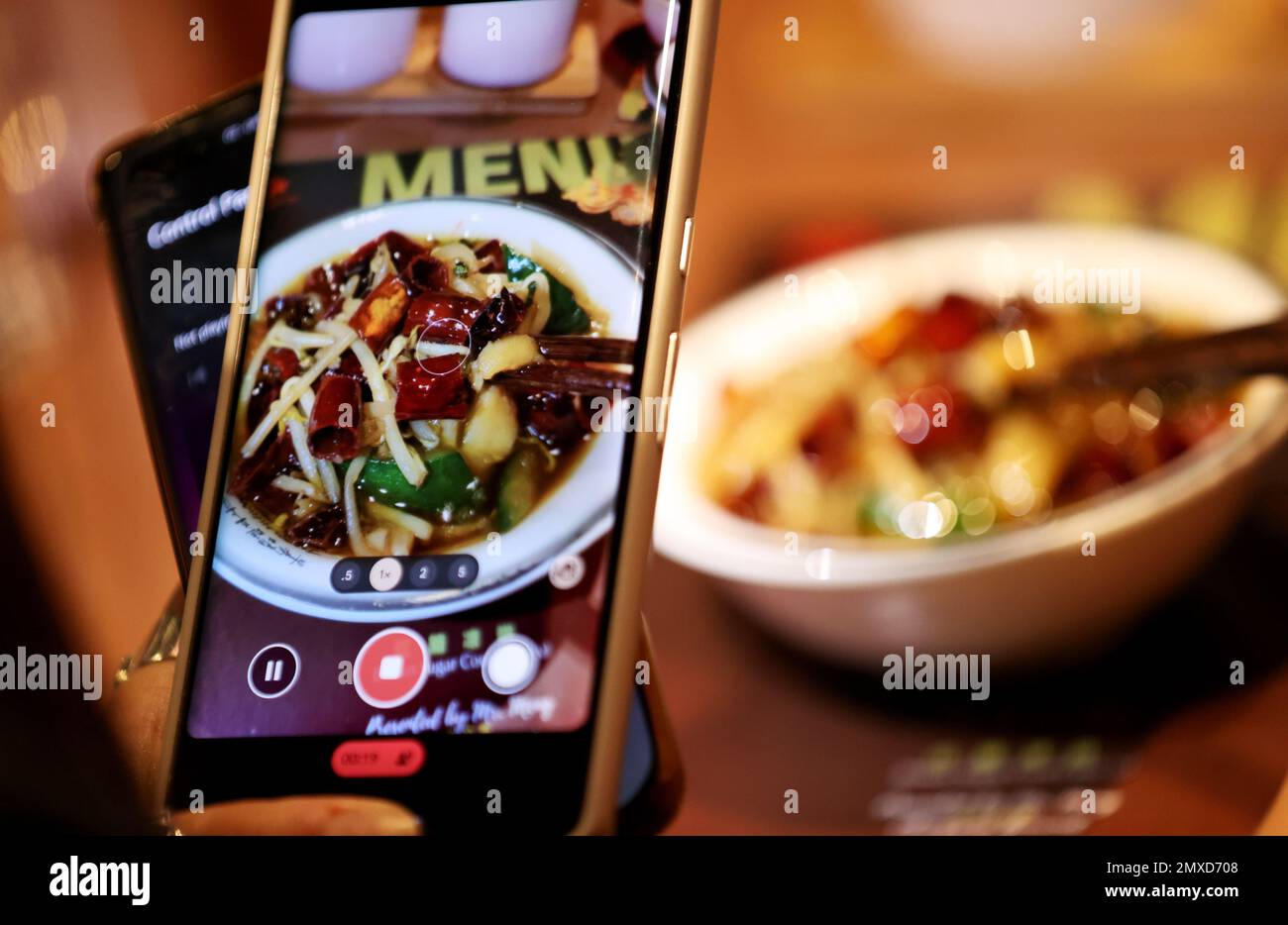 London, Britain. 2nd Feb, 2023. A customer takes photos of boiled spicy ...