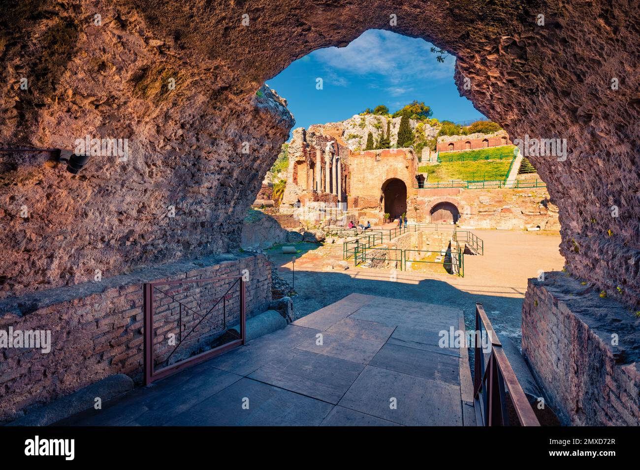 View from inside the stone arch of ruine of Greco-Roman theater, Sicily ...