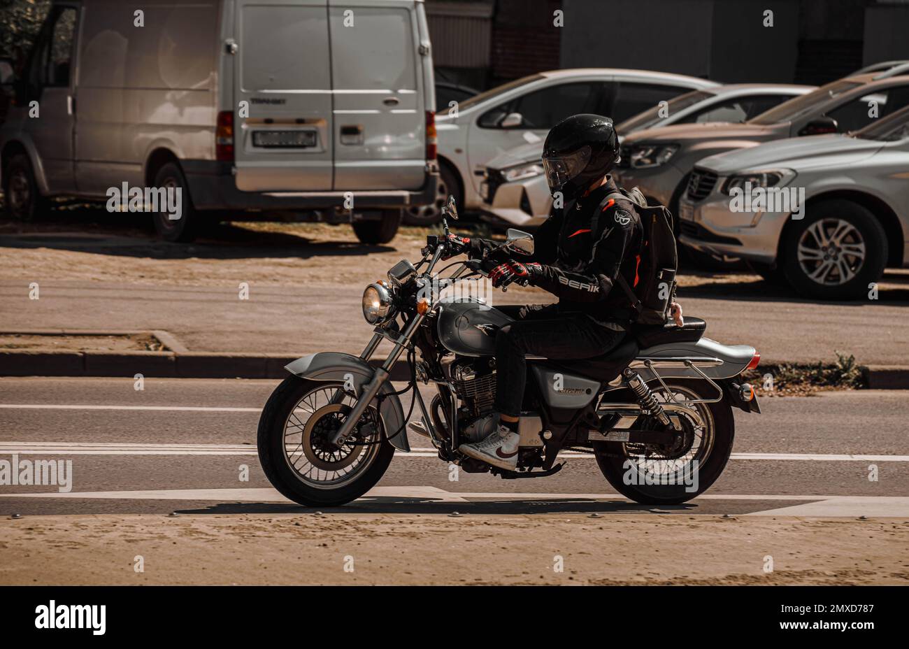 A motorist driving on a motorcycle on a street Stock Photo - Alamy