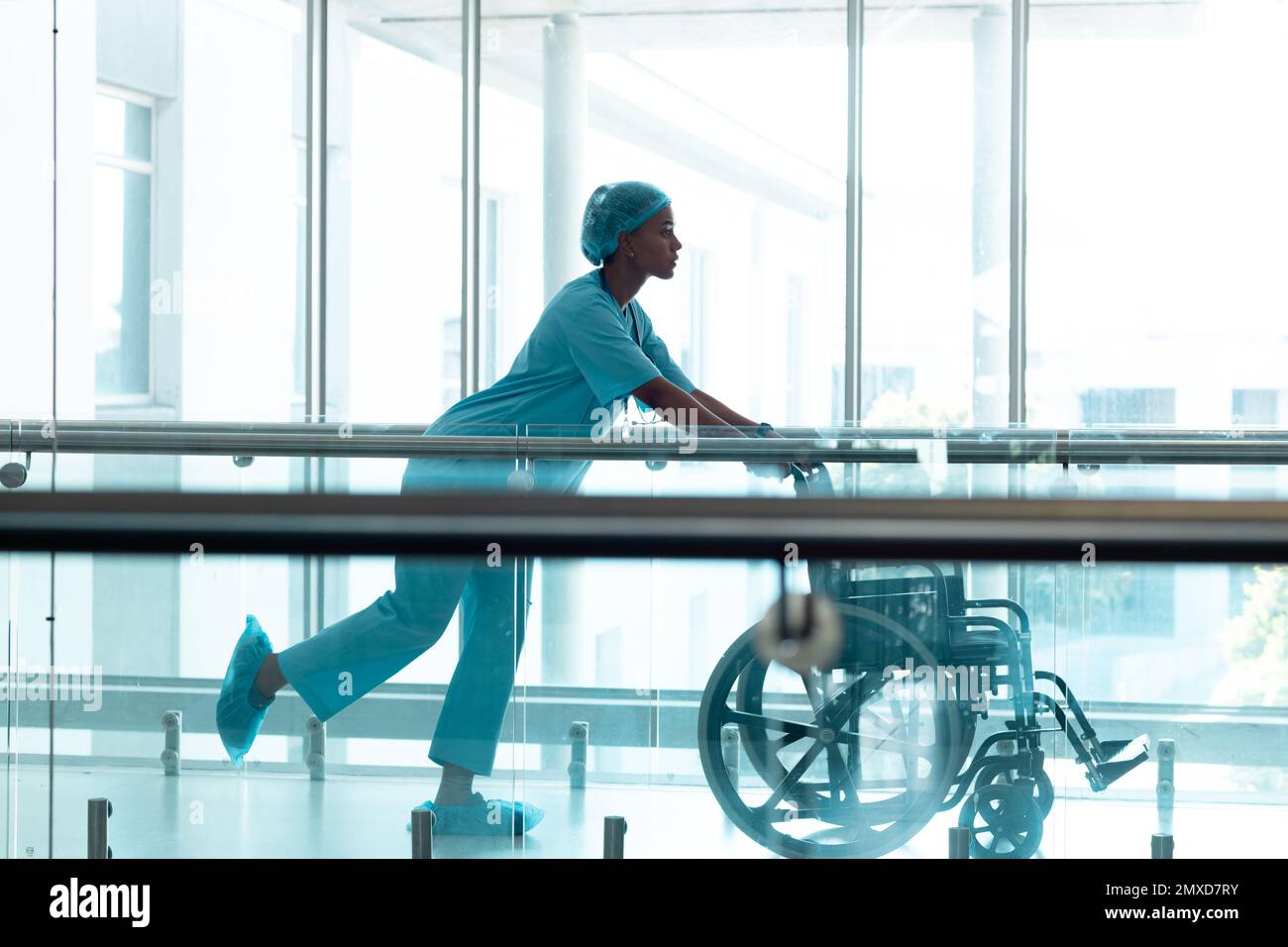 Biracial female doctor working at hospital, running and pushing ... Biracial female doctor working at hospital, running and pushing ...
