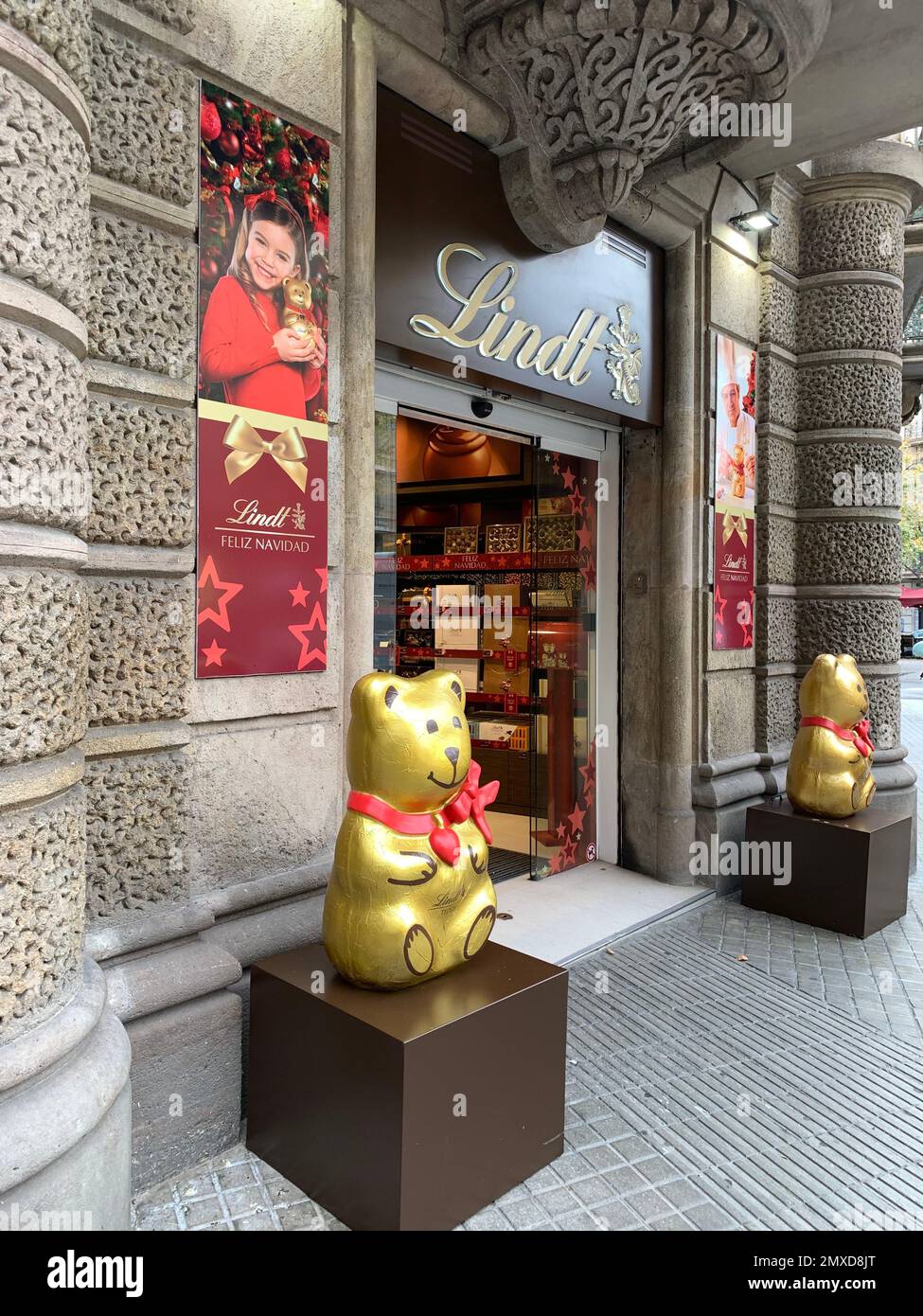 A vertical shot of a chocolate Lindt store with cute bear decorations ...