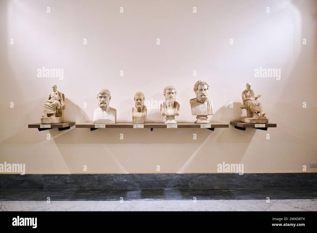 A collection of carved, white marble heads, busts of prominent men ...