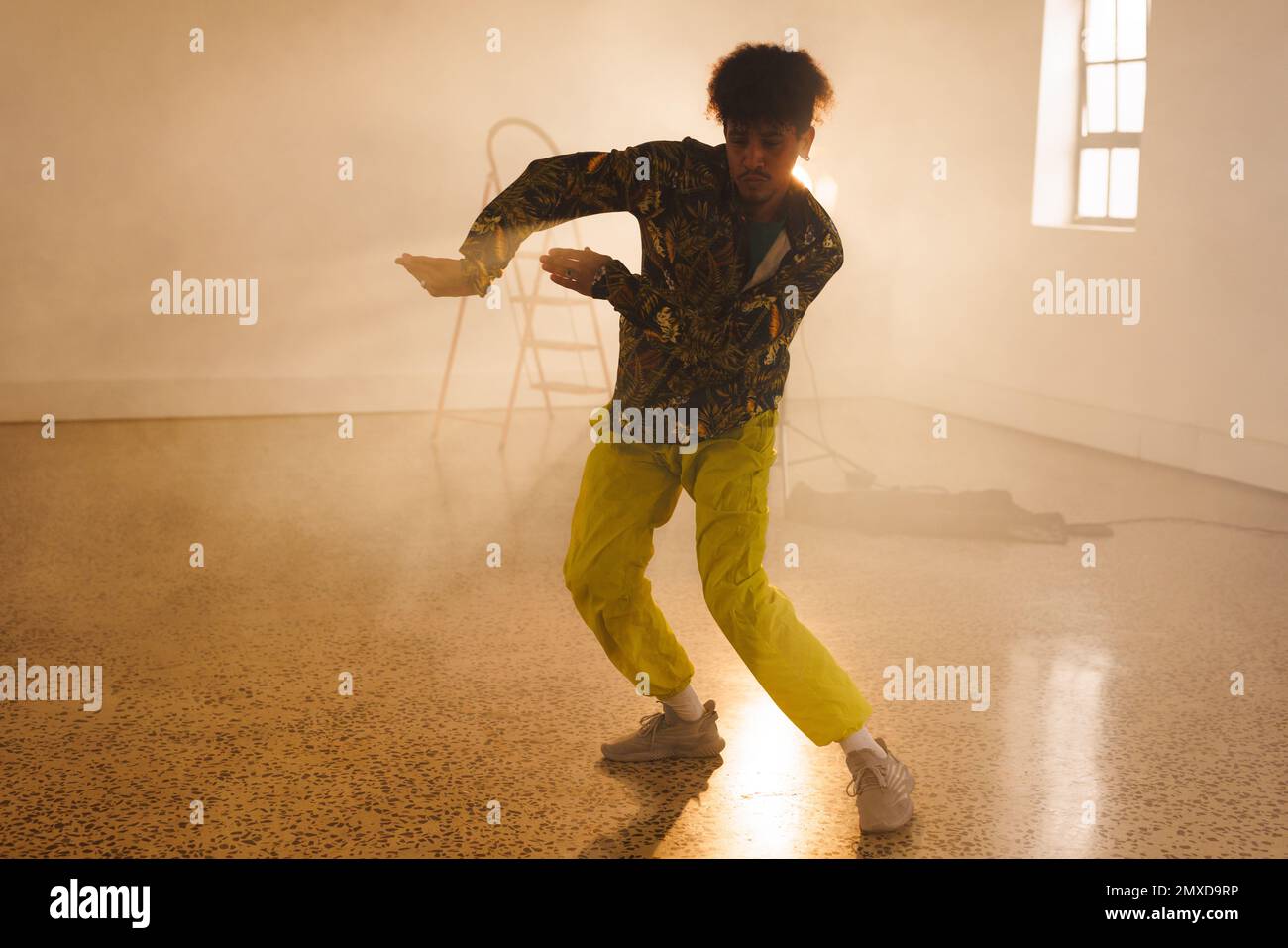 Image of biracial male modern dancer dancing in smoked interior. Dance ...