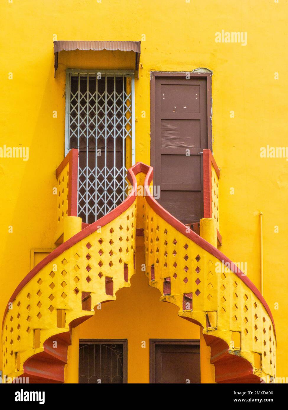 Colourful spiral staircase with metal gate and brown doors Stock Photo ...