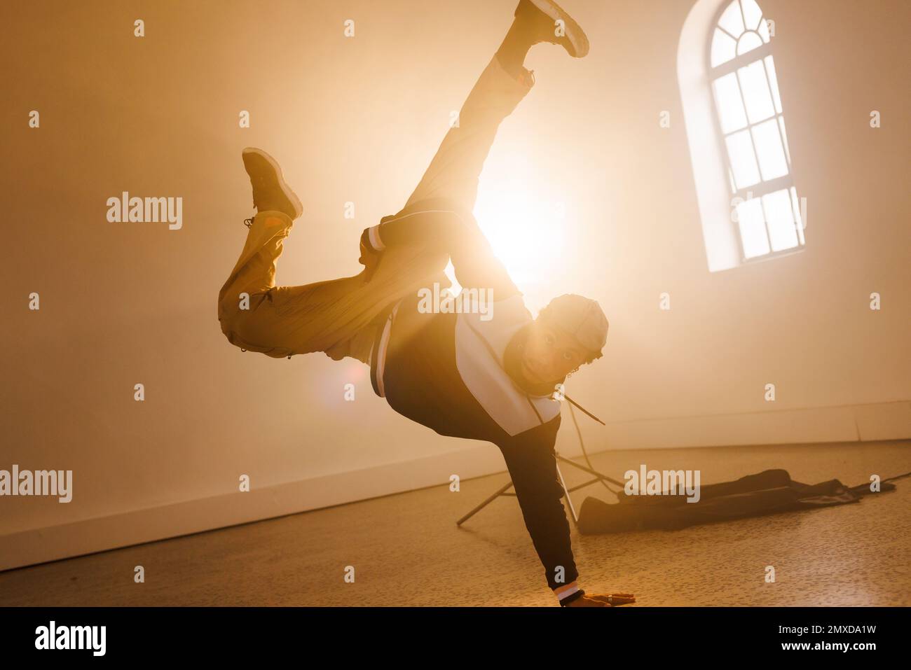 Image of biracial male hip hop dancer dancing in smoked interior. Dance ...